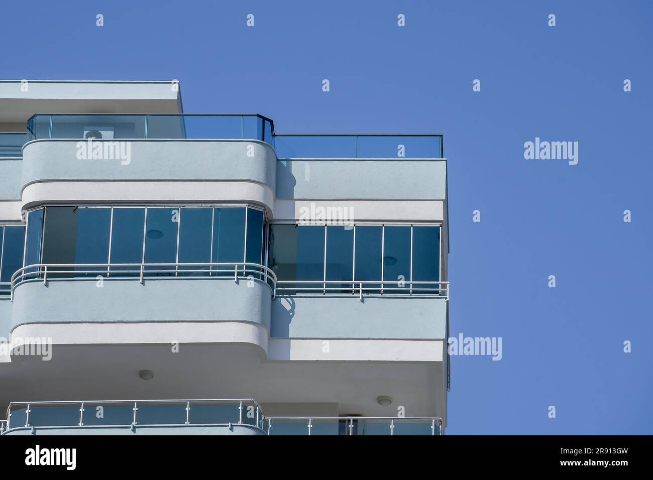 A fragment of a high-rise blue residential building with large ...