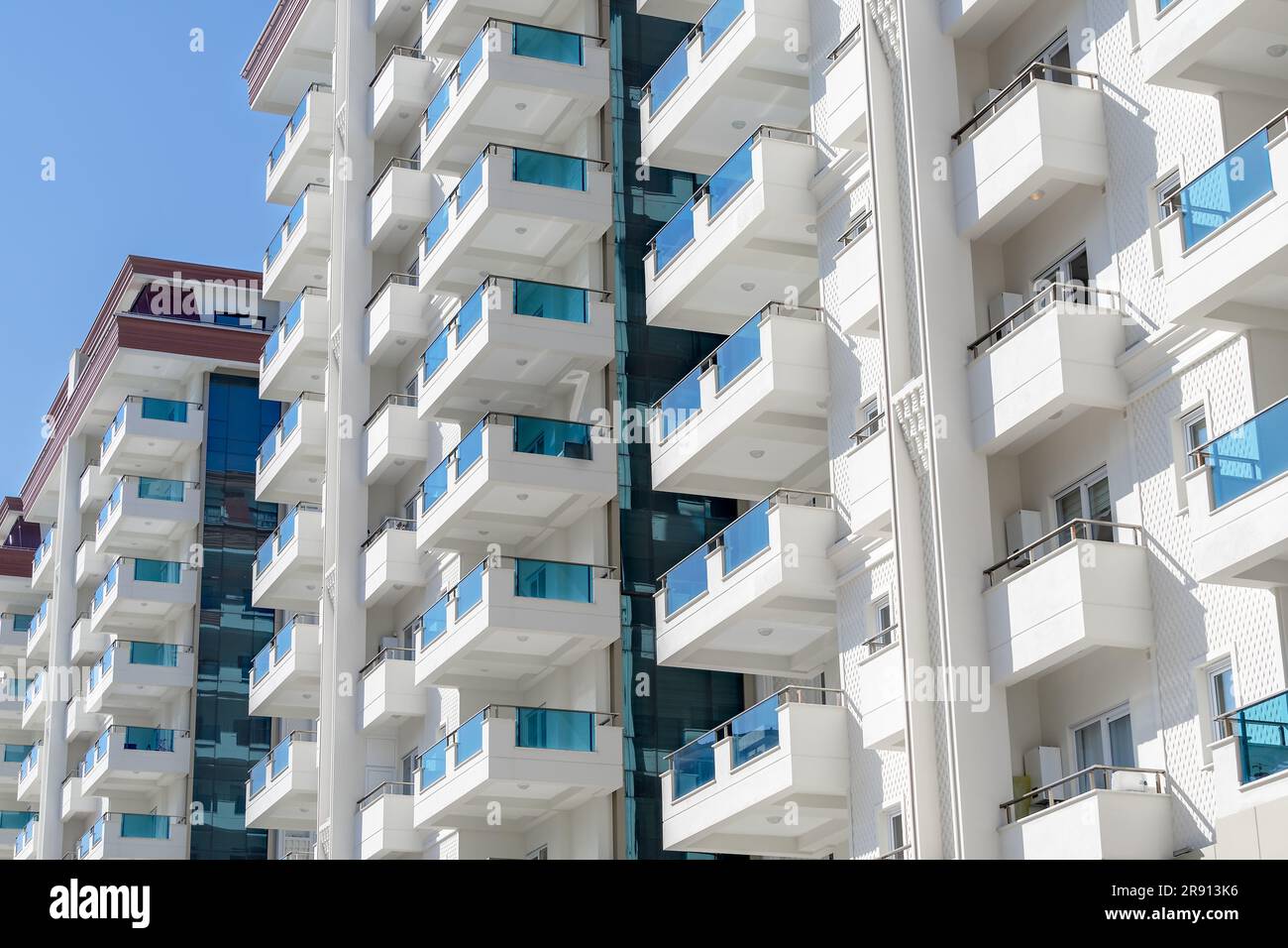 A row of high-rise apartment buildings with lots of balconies on a ...