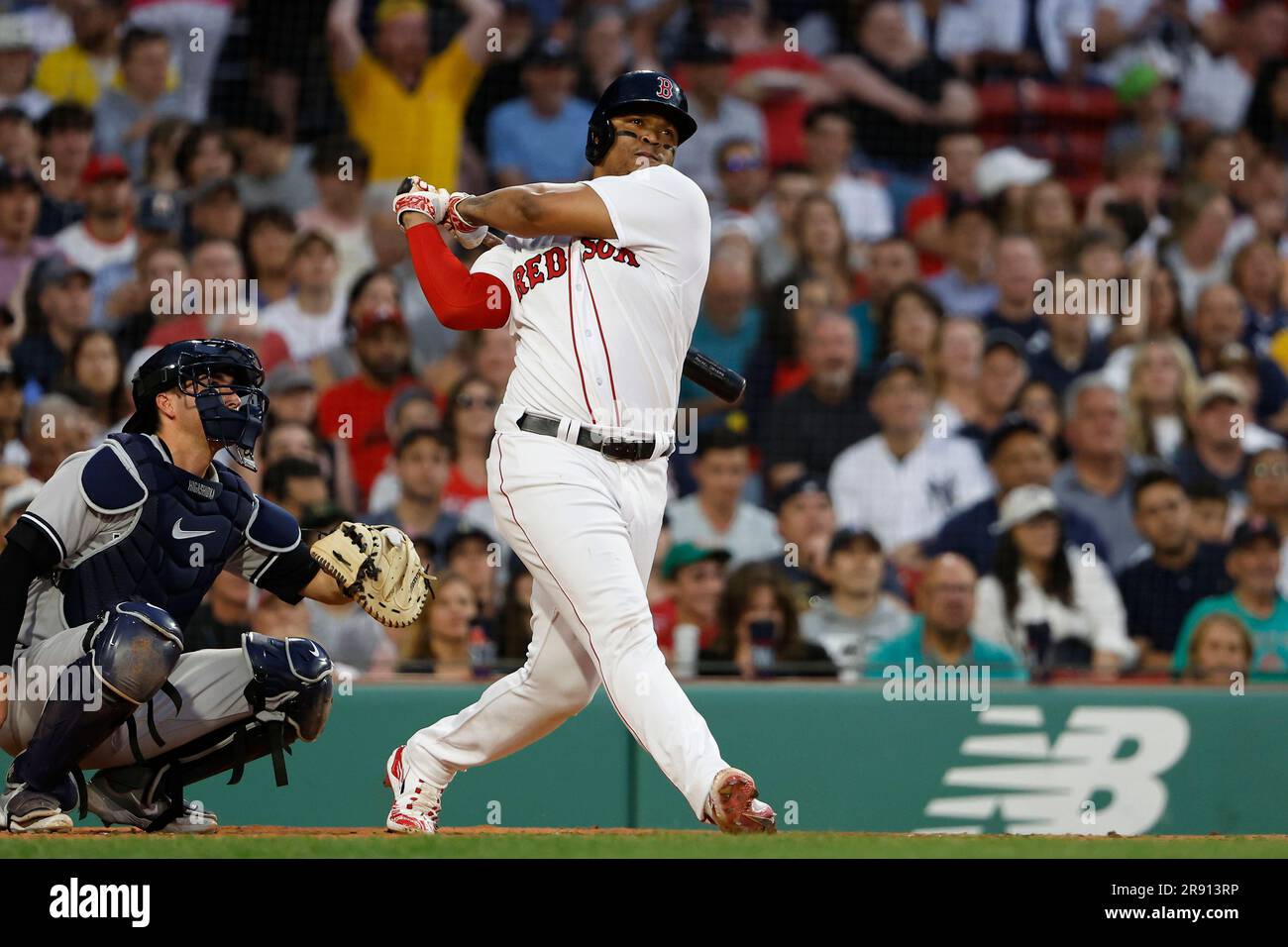 Boston Red Sox's Rafael Devers follows through on a hit against the New ...