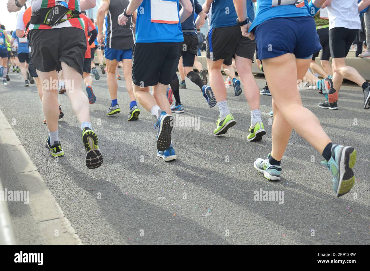 Marathon running race, many runners feet on road racing, sport ...