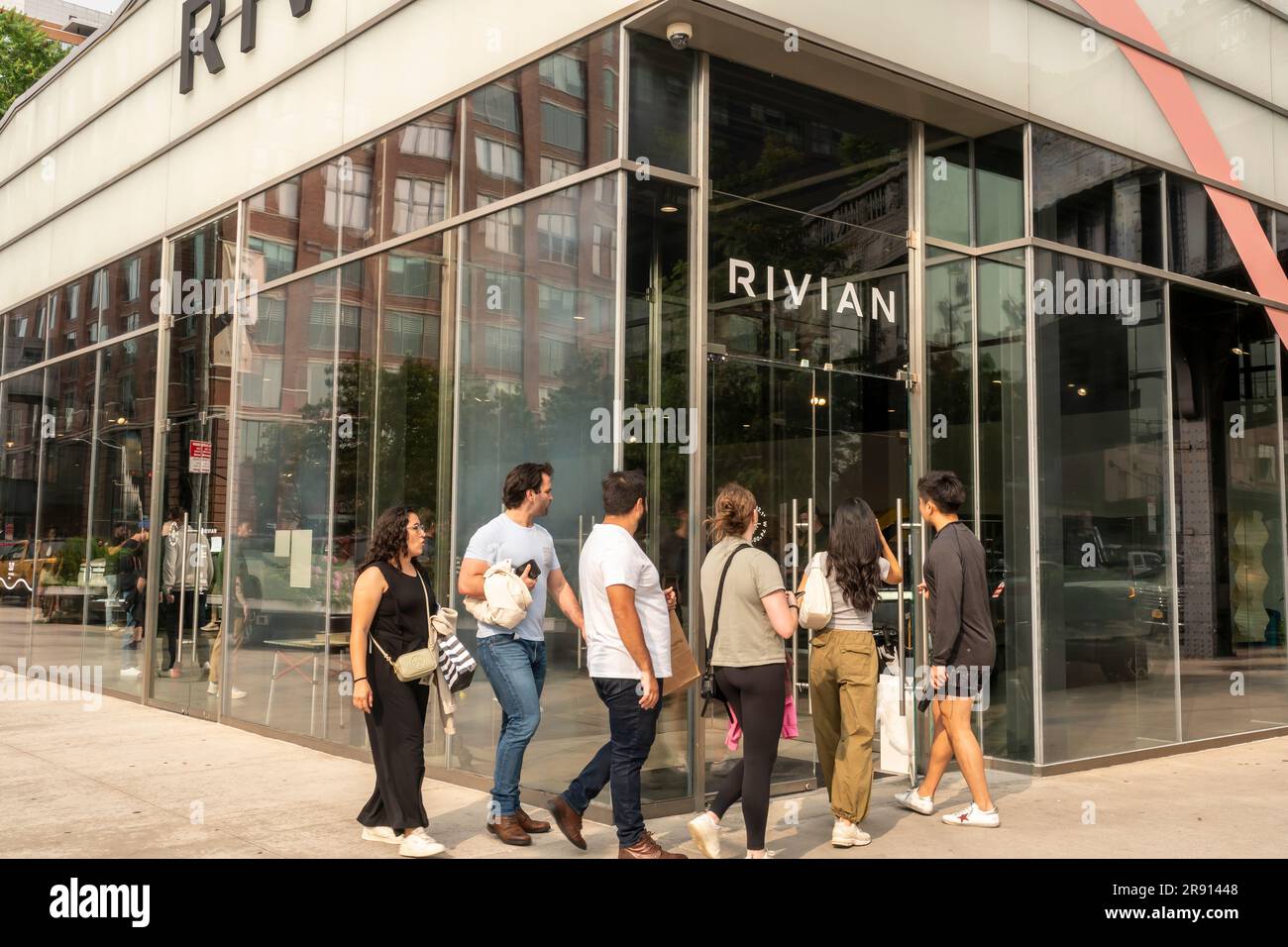 Automobile enthusiasts attend the grand opening of a Rivian Spaces ...