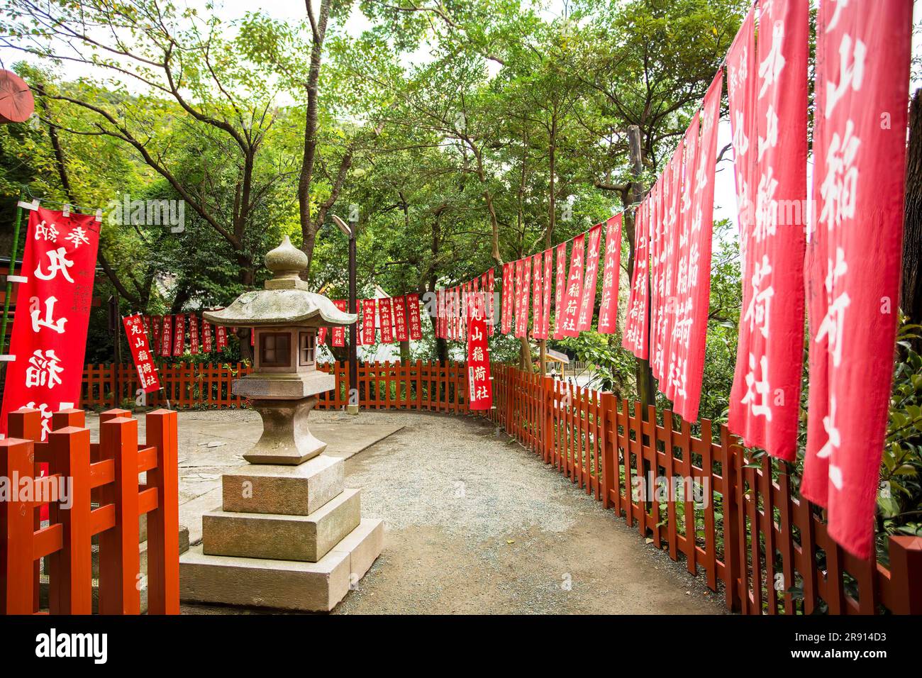 A Shinto lantern and red banners Stock Photo - Alamy