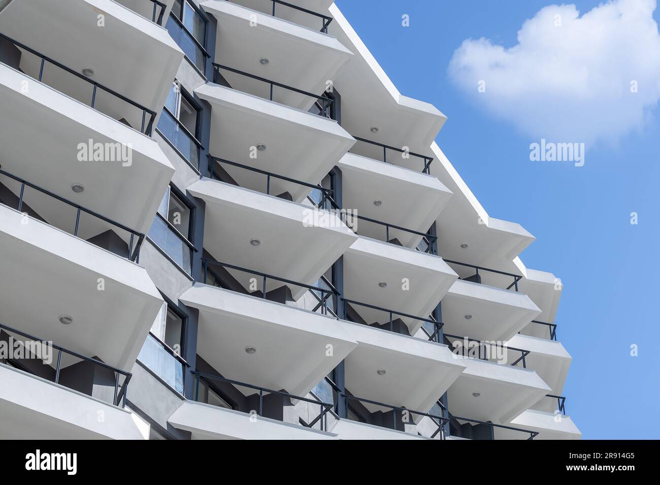 Part of a building with identical repeating triangular balconies ...