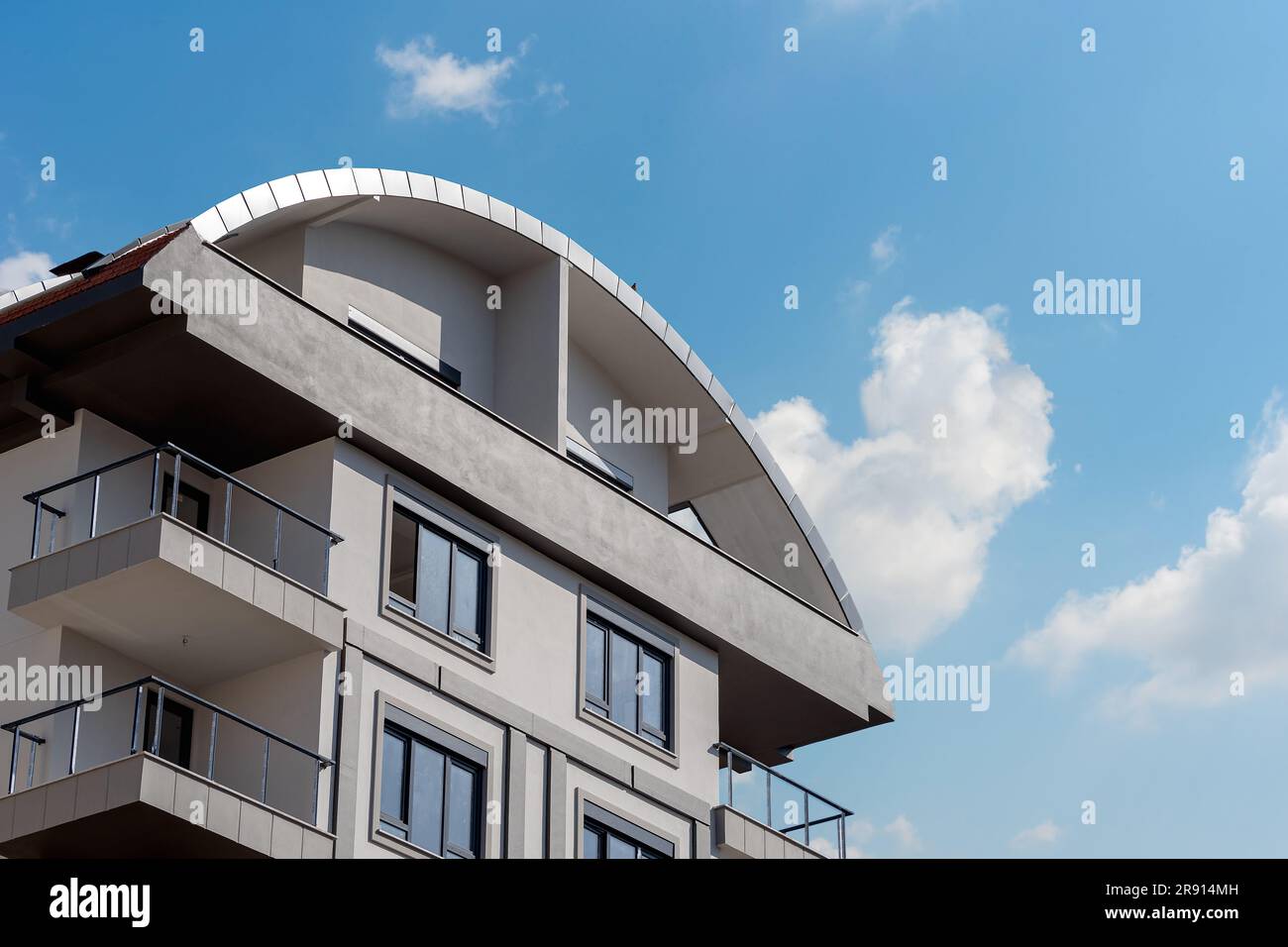 Part of an almost completed residential building against a blue sky ...