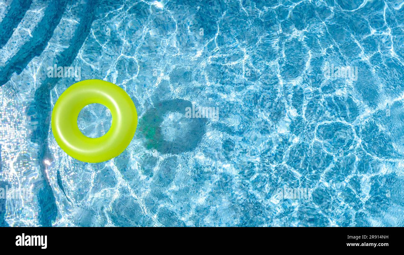 Сolorful inflatable ring donut toy in swimming pool water aerial view ...