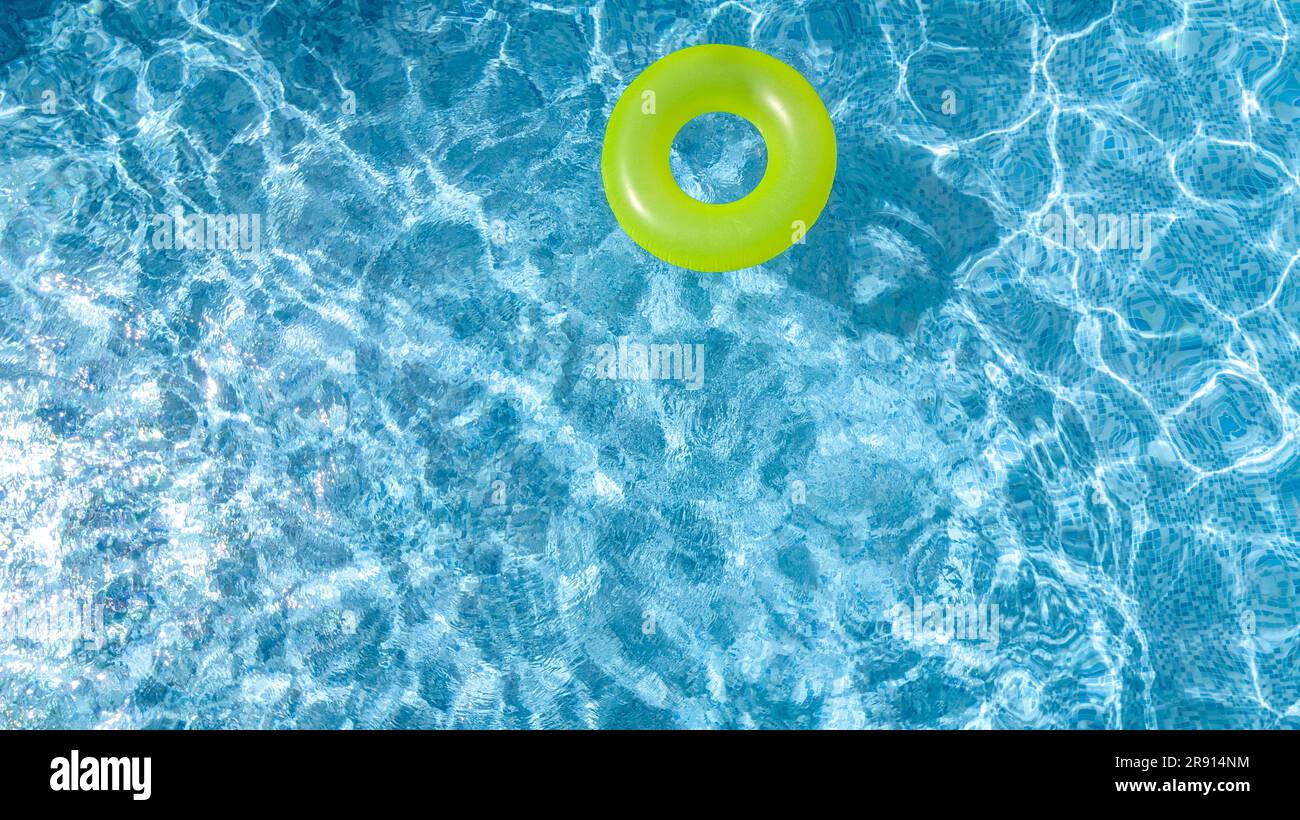 Сolorful inflatable ring donut toy in swimming pool water aerial view ...