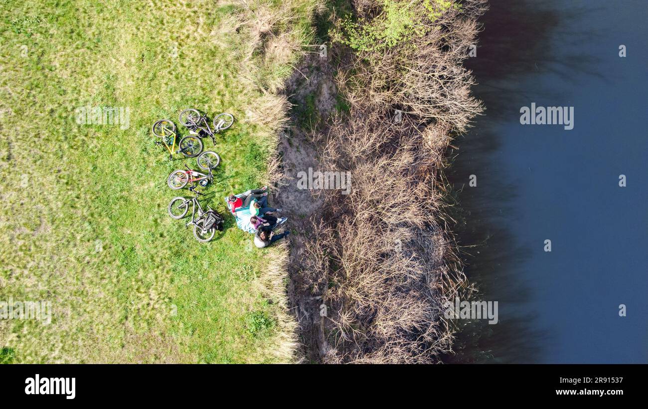 Family on bikes cycling outdoors, active parents and kids on bicycles ...