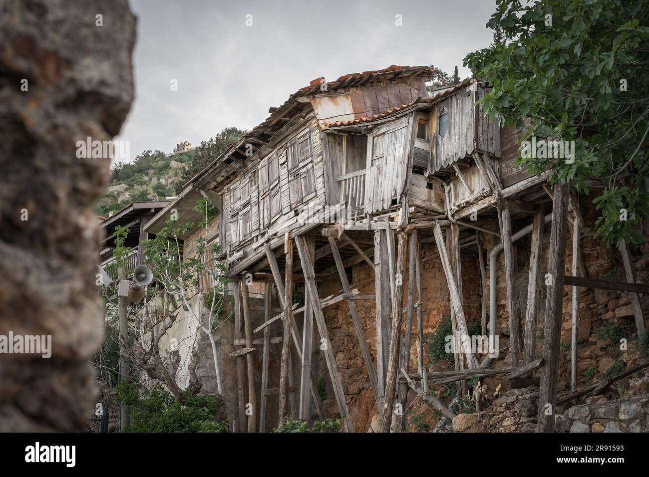 Dilapidated houses on one of the old streets of Alanya. Wooden building ...