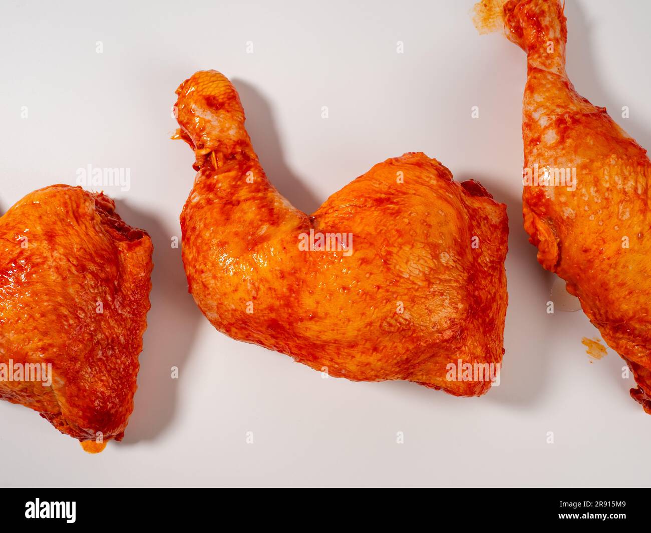 Marinated chicken drumstick or legs on a white plate. Marinated chicken ...