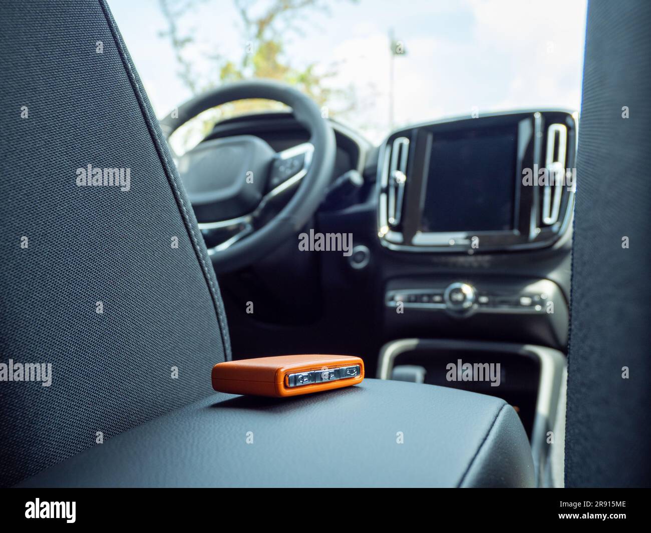 Car ignition key on the armrest in the interior of a modern car. Forgot ...