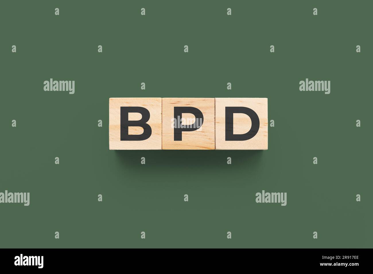 BPD (Borderline Personality Disorder) wooden cubes on dark green ...