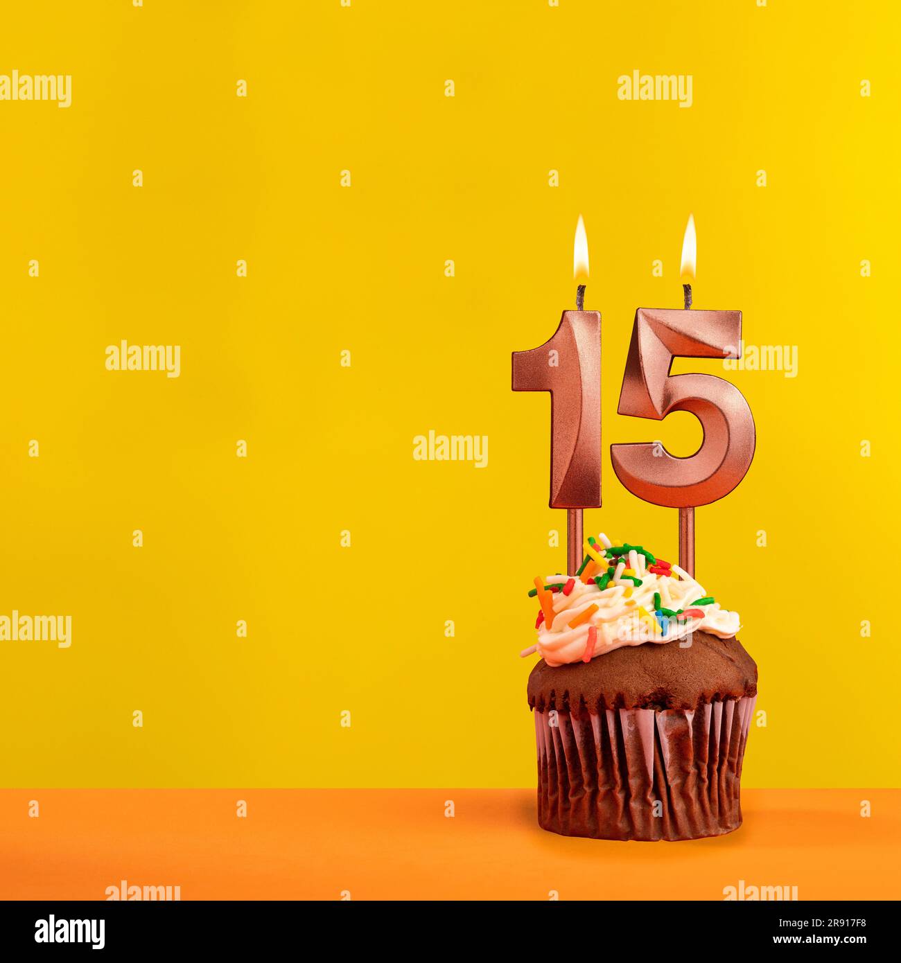 Candle with flame number 15 - Birthday card on yellow background Stock ...
