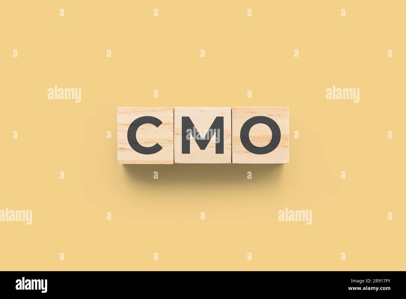 CMO (Chief Marketing Officer) wooden cubes on yellow background Stock ...