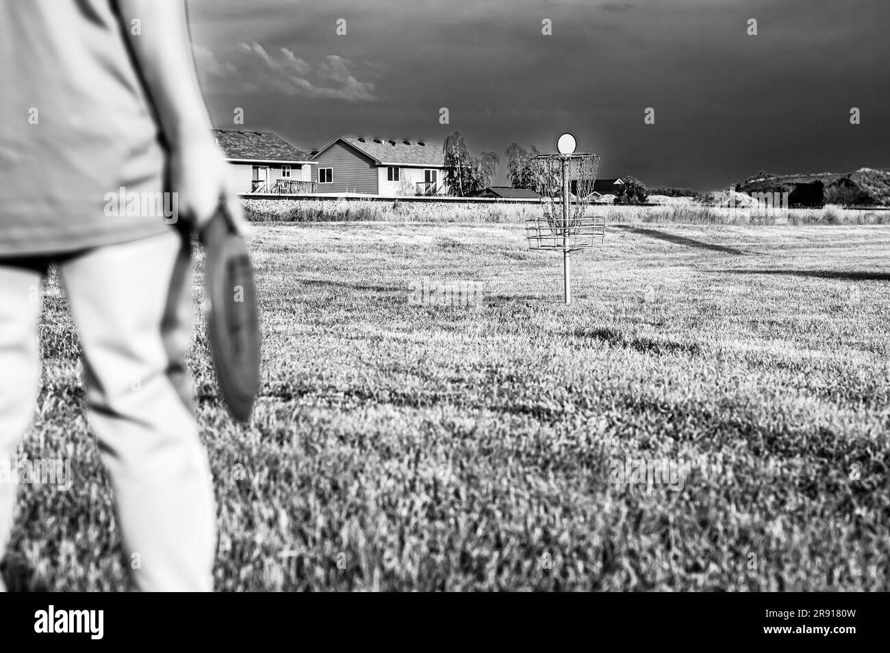 Selective focus fairway grass with a defocused young child holding a ...