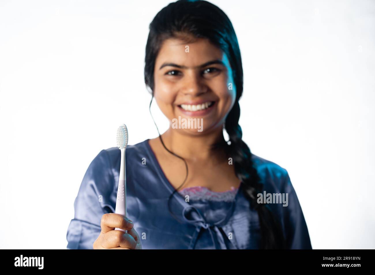 An Indian woman female girl showing tooth brush on white background ...