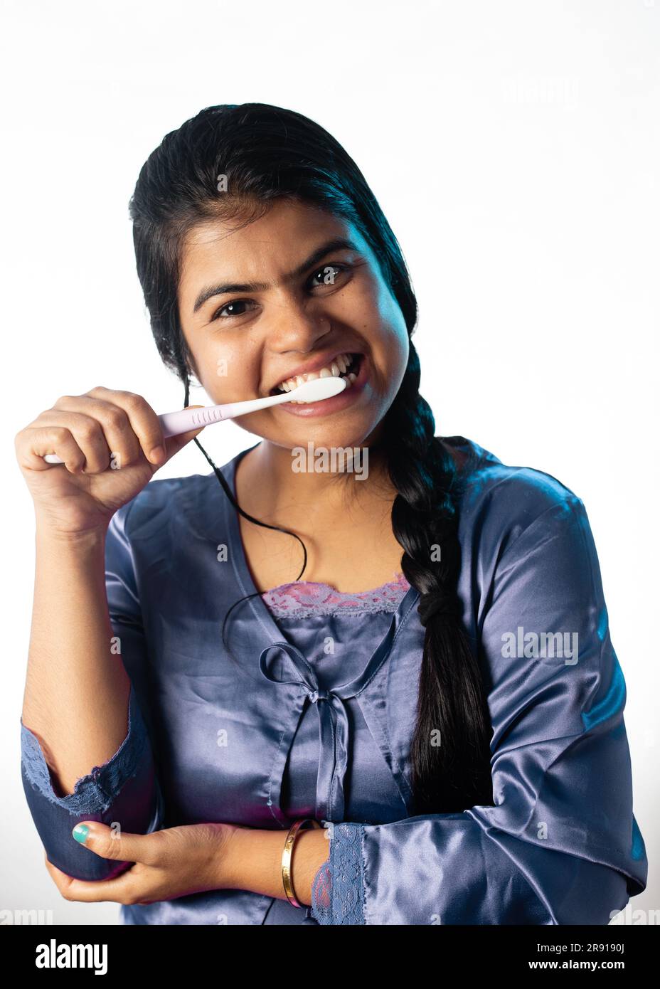 An Indian woman female girl brushing teeth on white background with ...