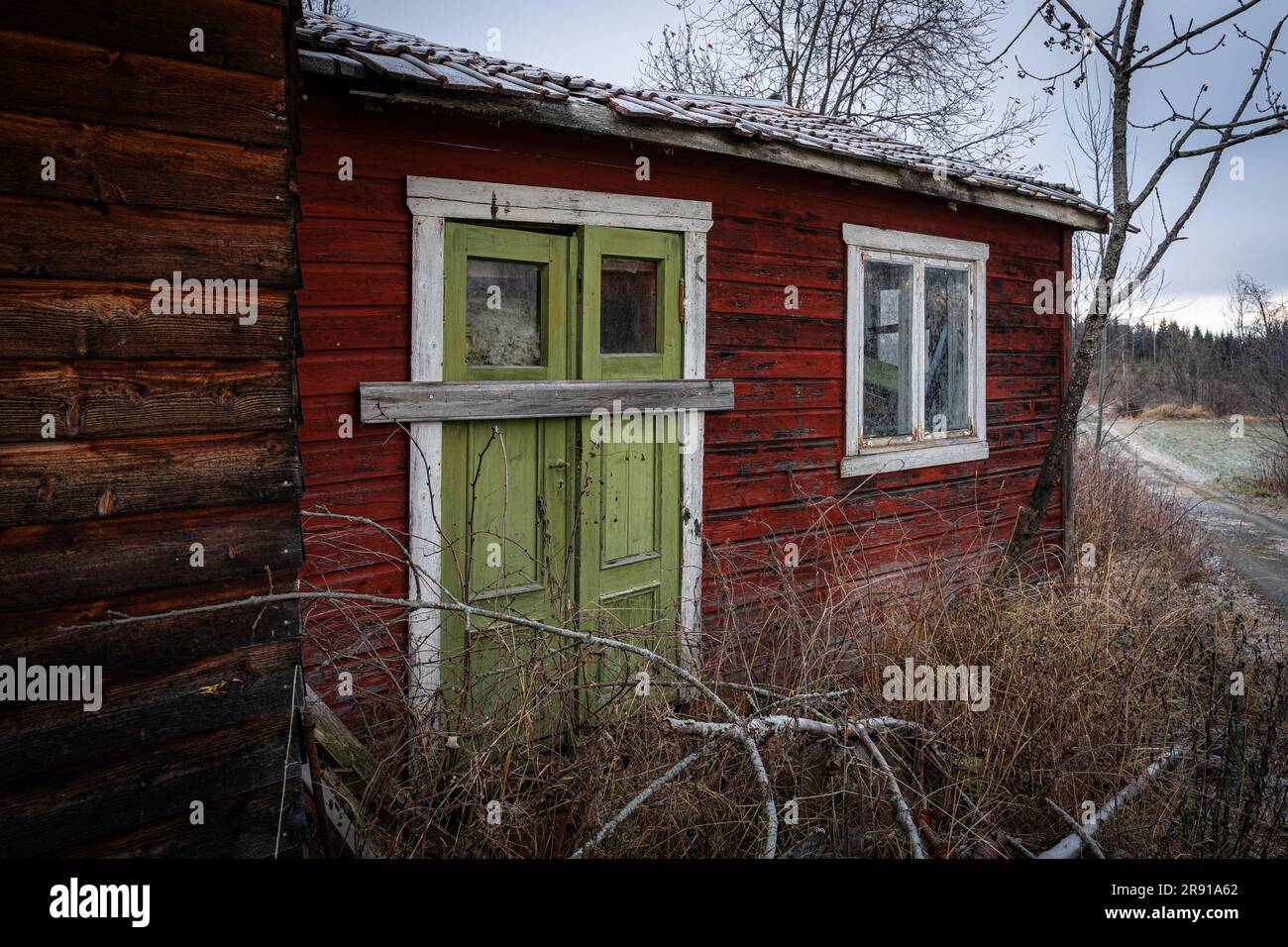 A vintage wooden barn with a vibrant green door and window near Toten ...