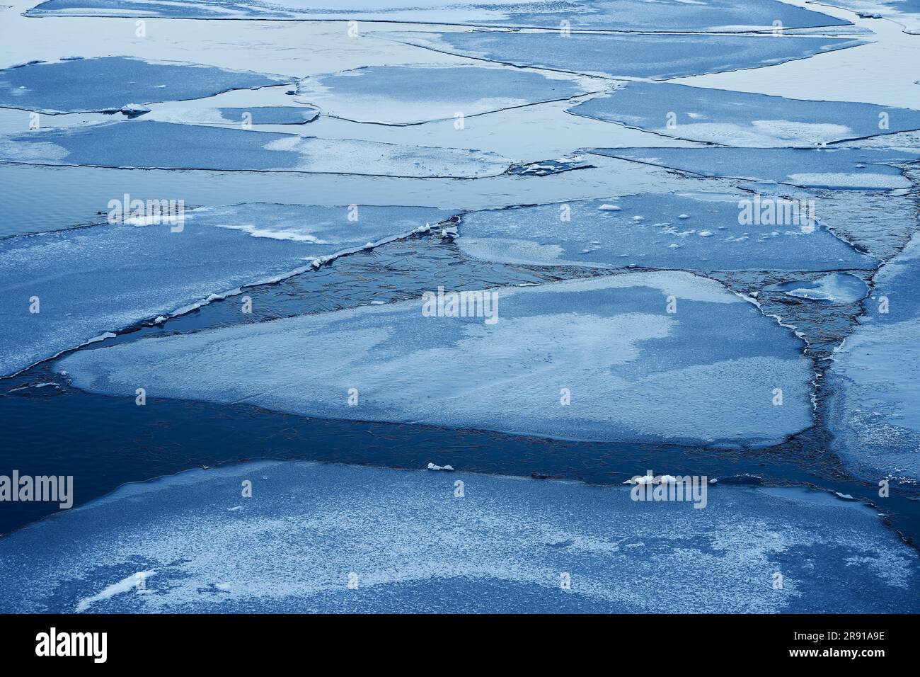 A beautiful shot of the partially frozen bright blue Lake Mjosa in ...