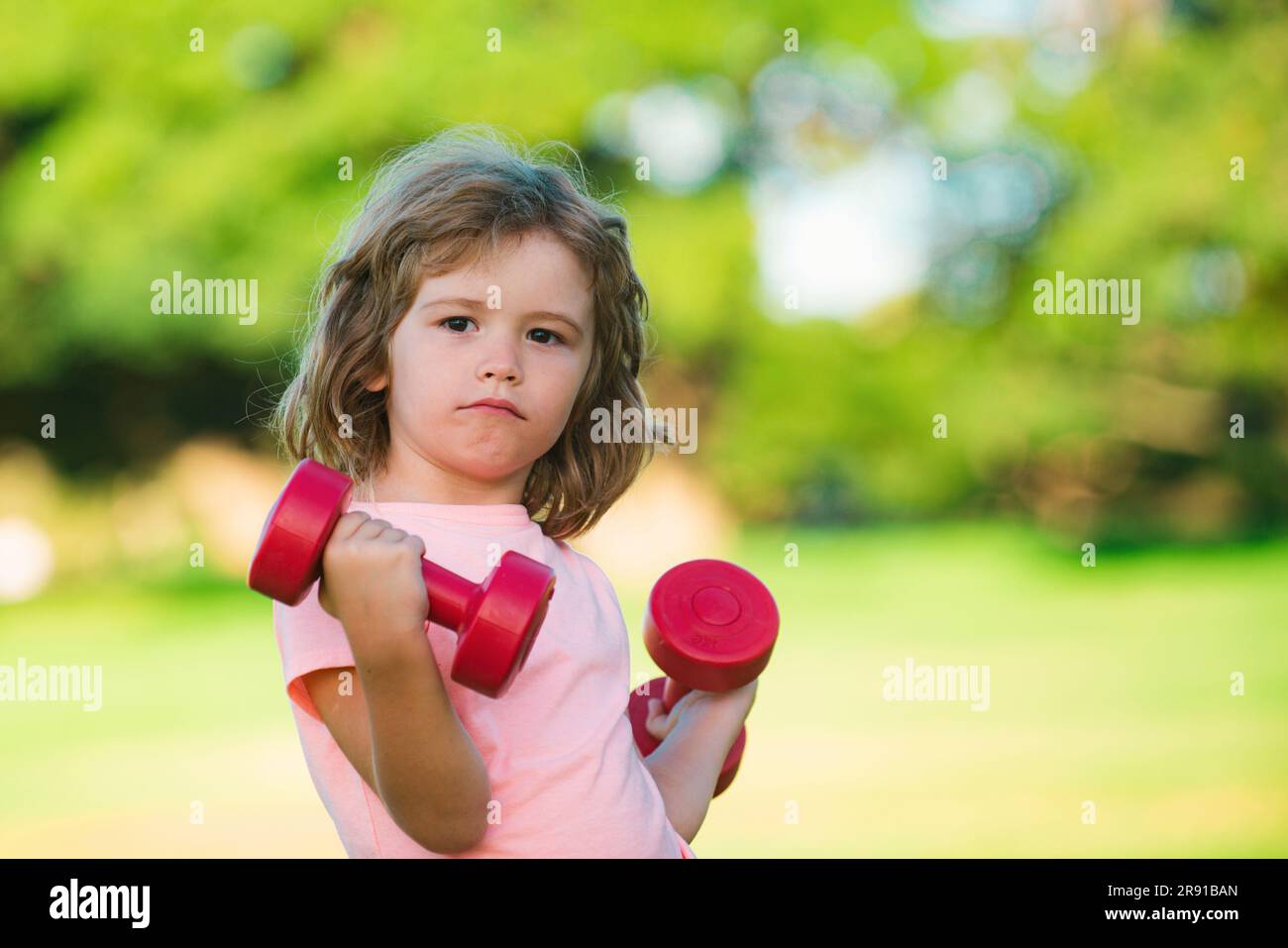 Fitness dumbbells kid exercise workout outdoor. Boy sporty child with ...