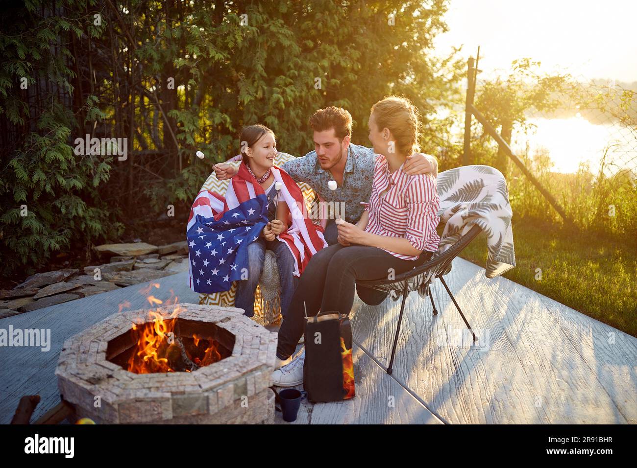 The parents and their daughter come together around a crackling fire ...