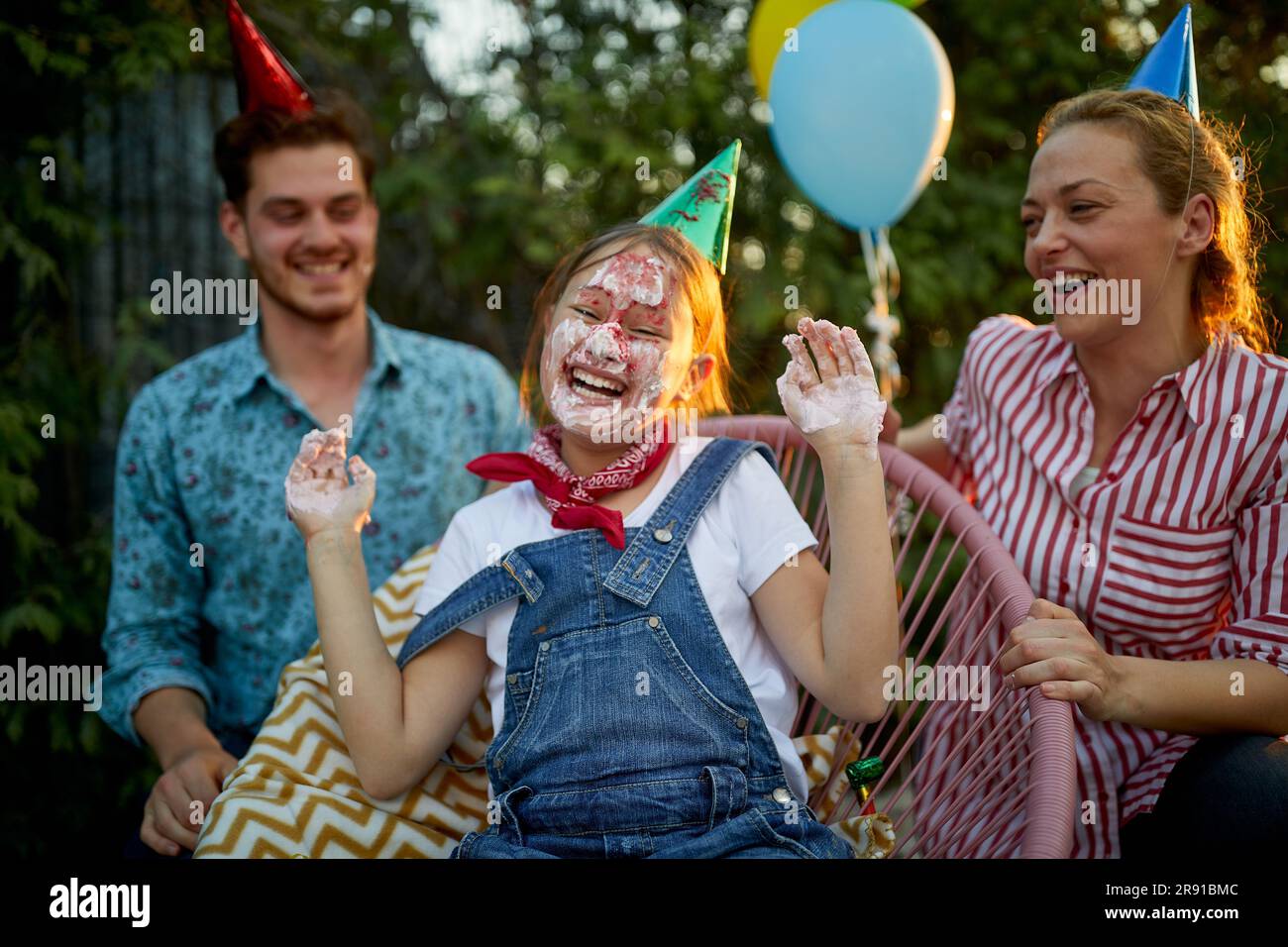 Joyful moment as parents celebrate their daughter's birthday. With ...