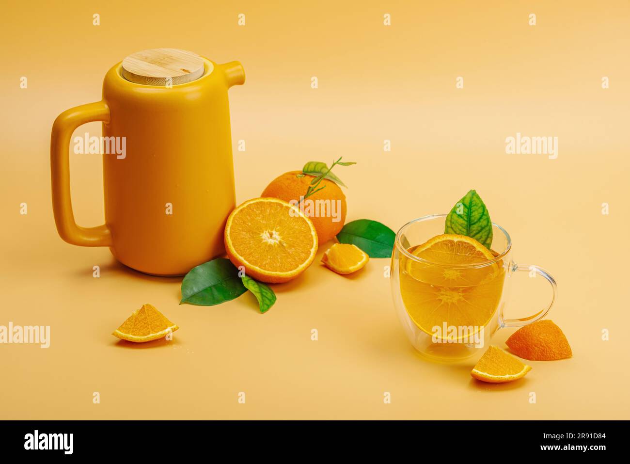 Orange tea in ceramic tea pot with ripe fruits. Refreshment seasonal ...