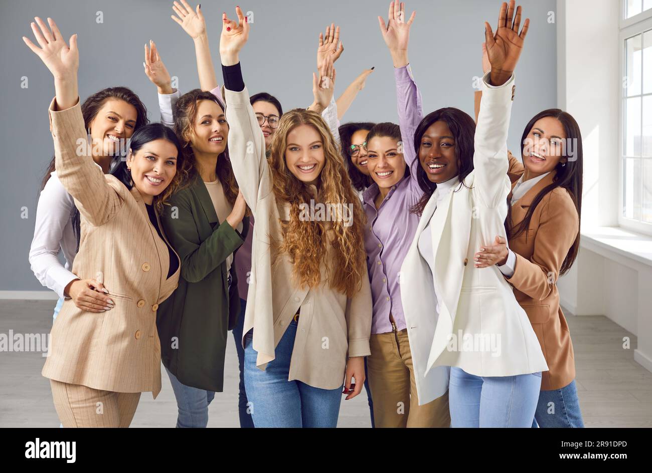 Team of happy diverse business women standing together, waving their hands and smiling Stock ...