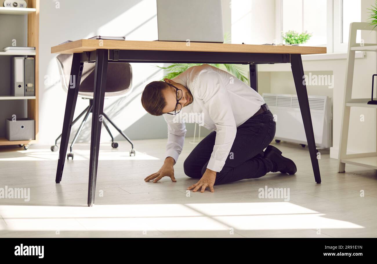 Hiding Under Desk Office Worker