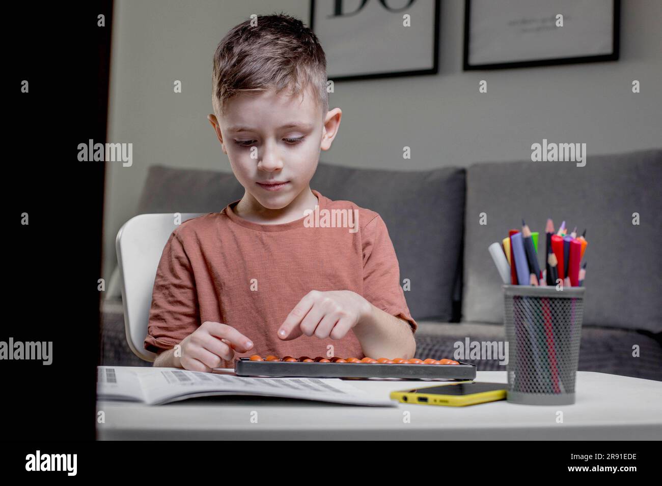 Little preschooler counting large numbers on his fingers using mental ...