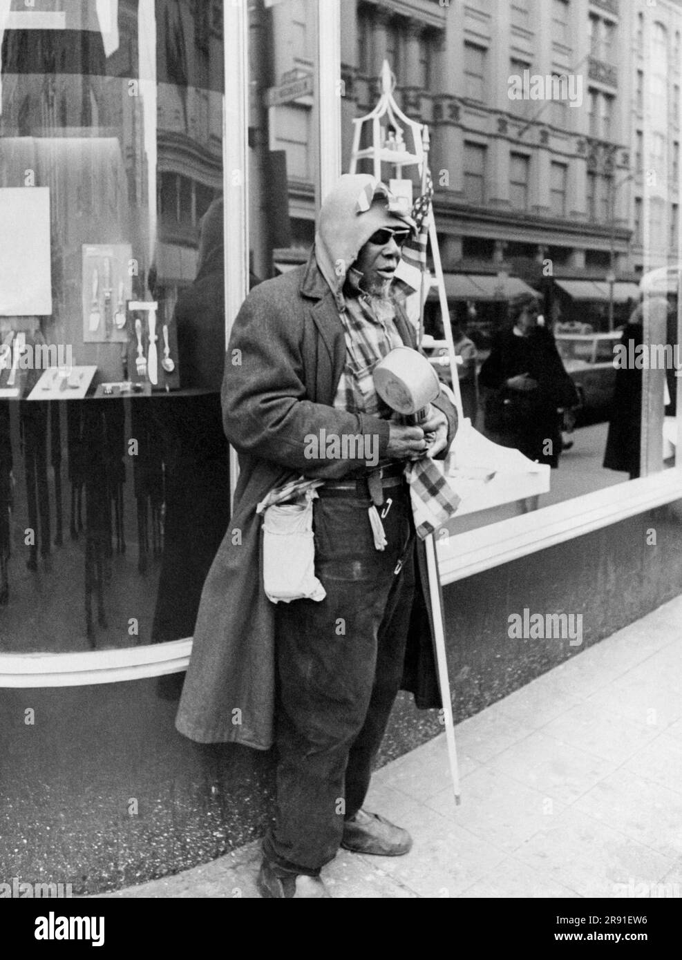 Baltimore, Maryland: c. 1964 A blind man waits for handouts outside a ...
