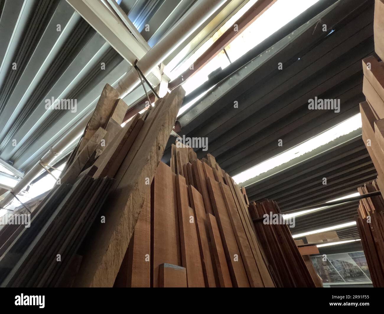 Lumber with vertical boards of tropical wood in an industrial warehouse ...