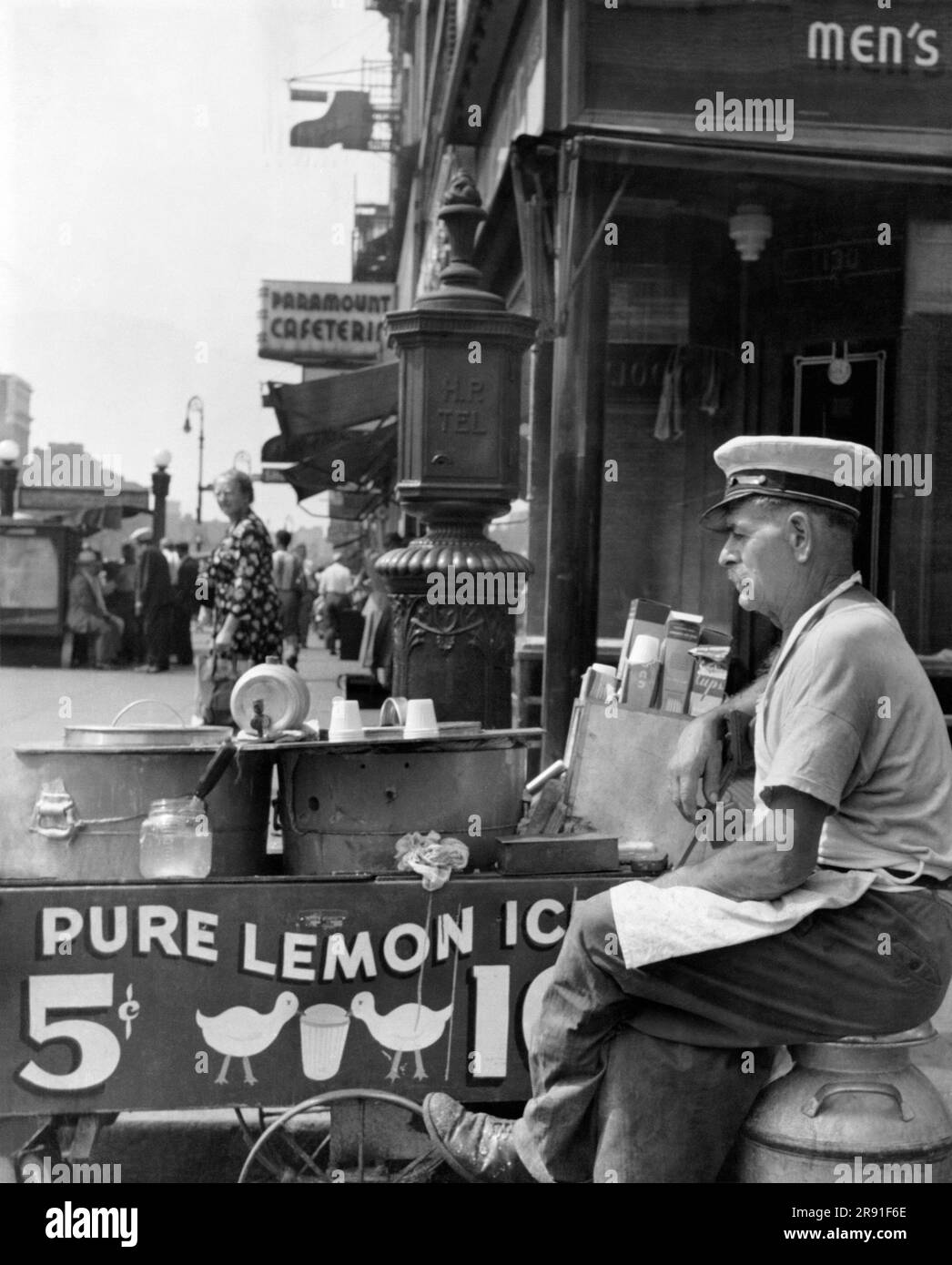 United States: c. 1950 A lemon ice vendor sits by his cart Stock Photo ...