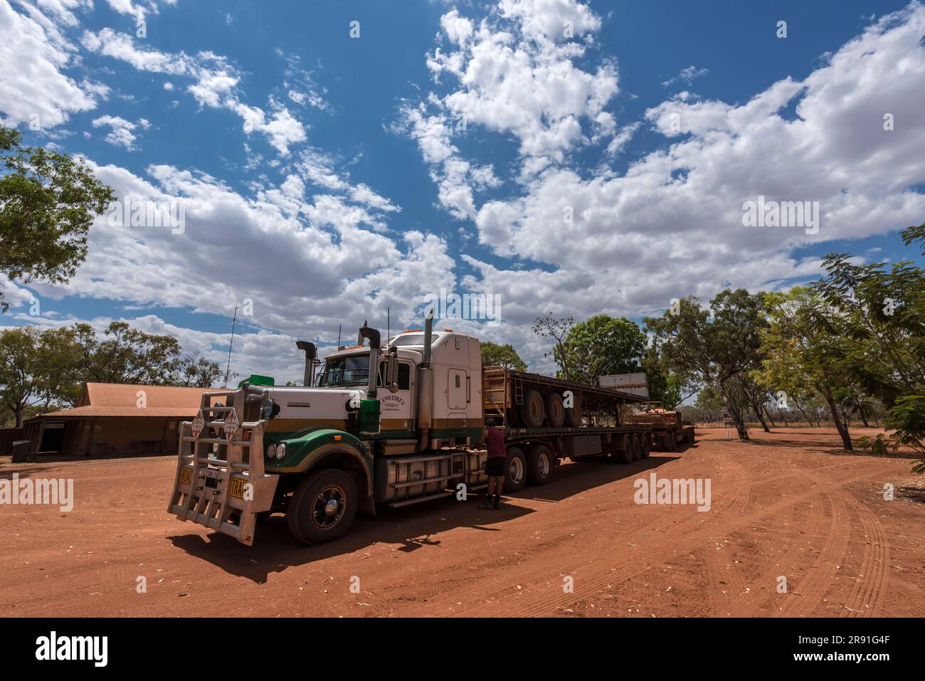 A road train waits on the red soil at the road house in Mount Barnett ...