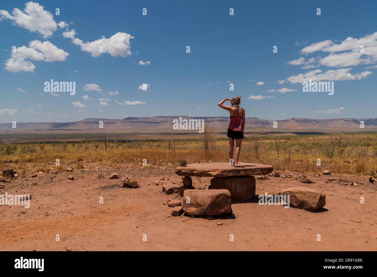 A woman stands on a rock table to enjoy the view towards the Cockburn ...