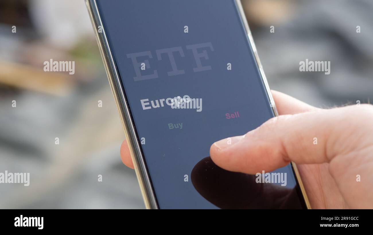 An investor looking at an Europe ETF on his smartphone. Investment in ...