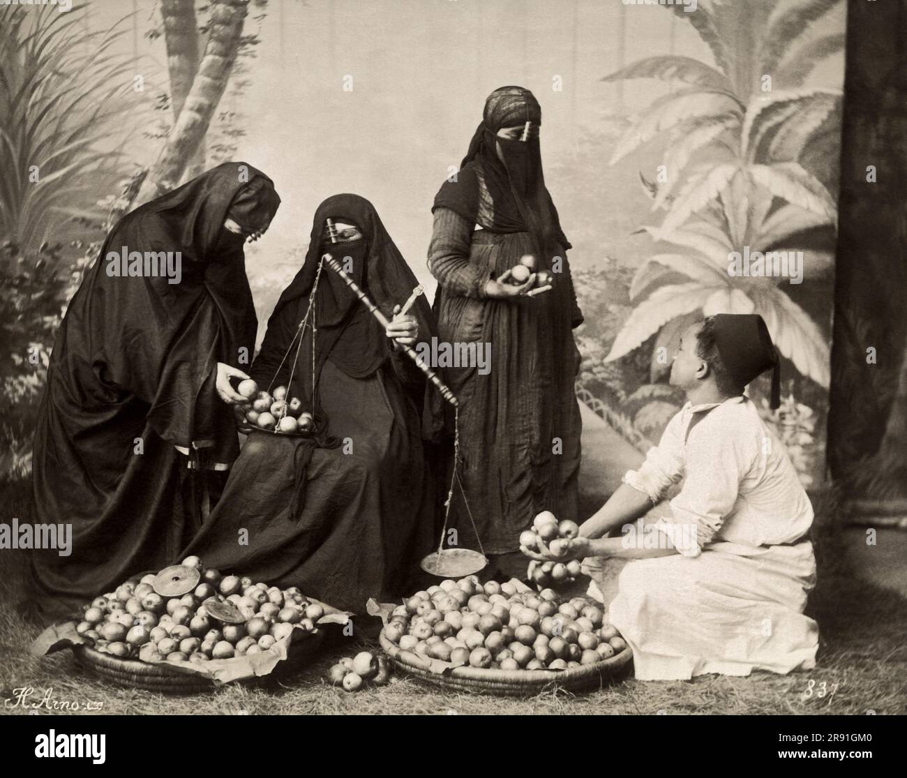 MIddle East: c. 1890 An albumen print of three Arab women using a scale ...