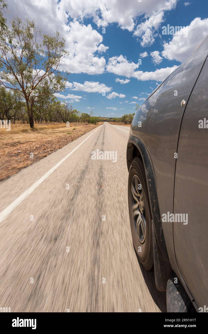 A car driving along a long road in the Australian Outback Stock Photo ...