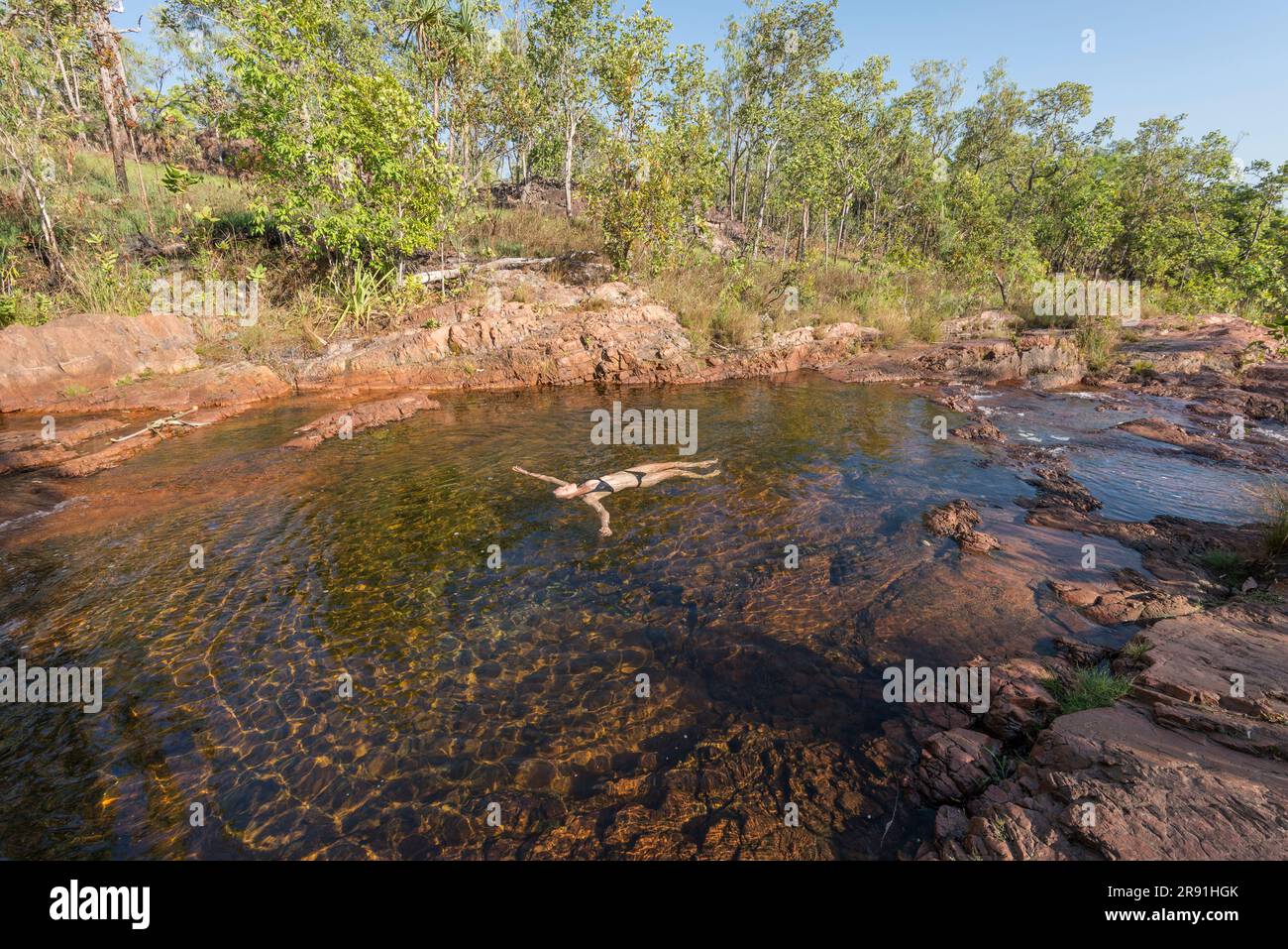 A woman floats on her back in the freshwater rockpools of Buley ...