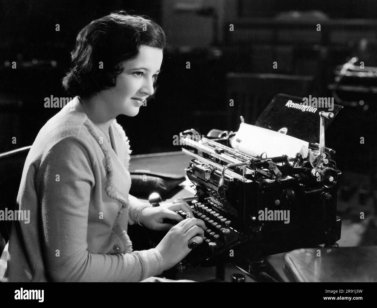 Hollywood, California: 1931 Actress Arline Judge types a letter on a ...