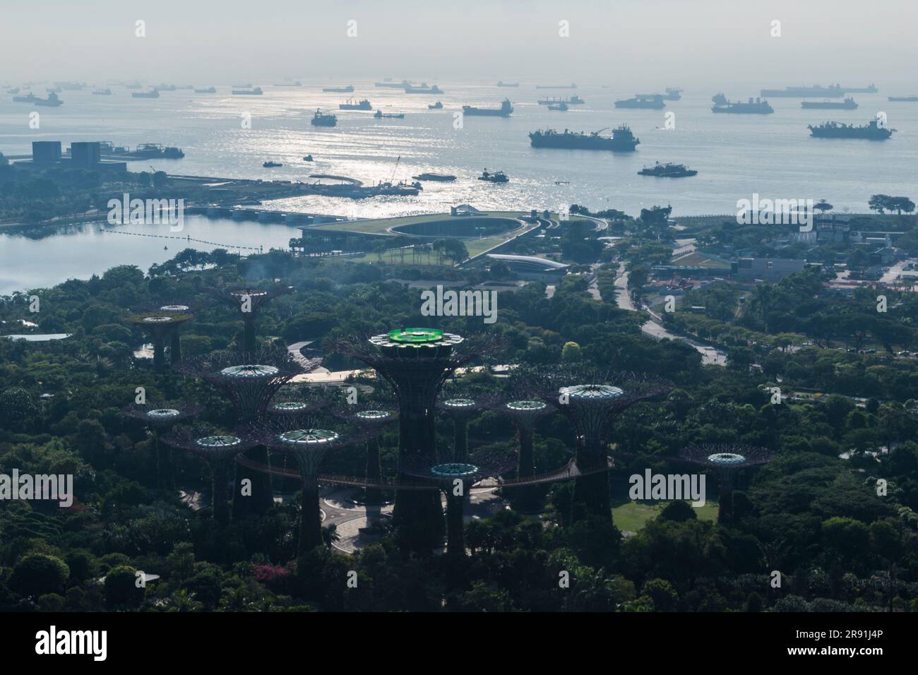An elevated view of Singapore with container ships waiting off shore ...