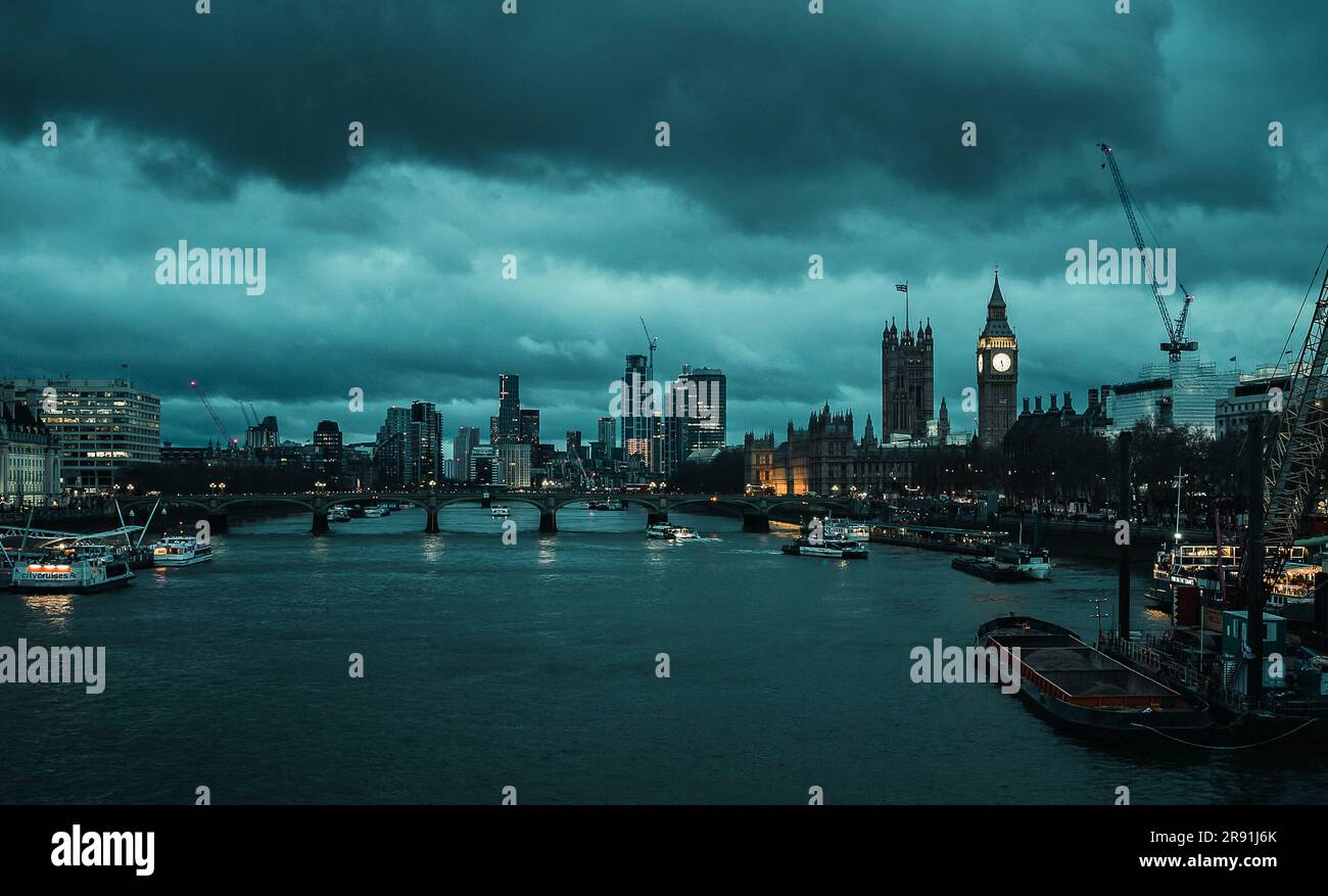 Some boats docked on the iconic River Thames at night, with the ...