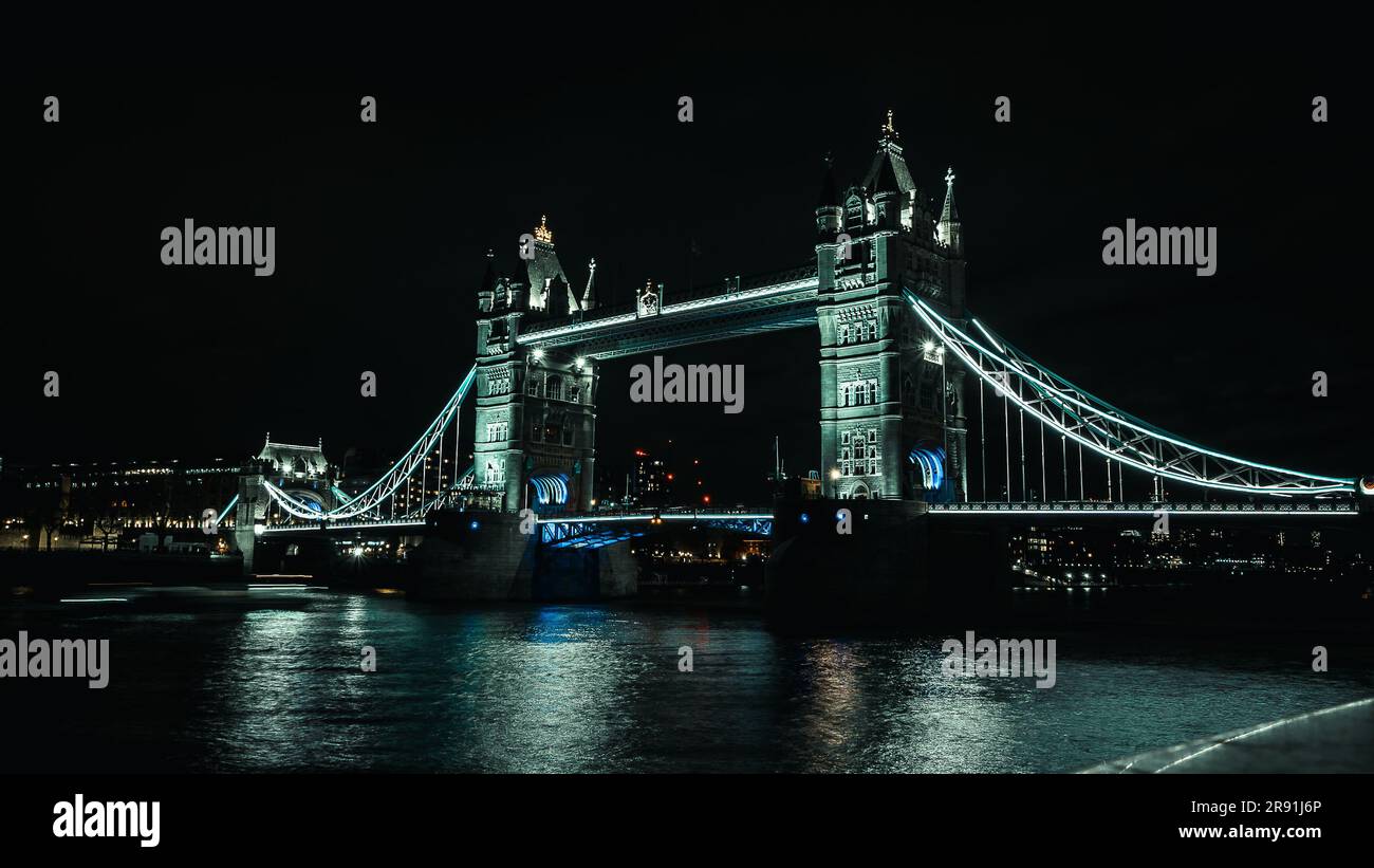 A majestic view of London's iconic Tower Bridge at dusk, illuminated in ...