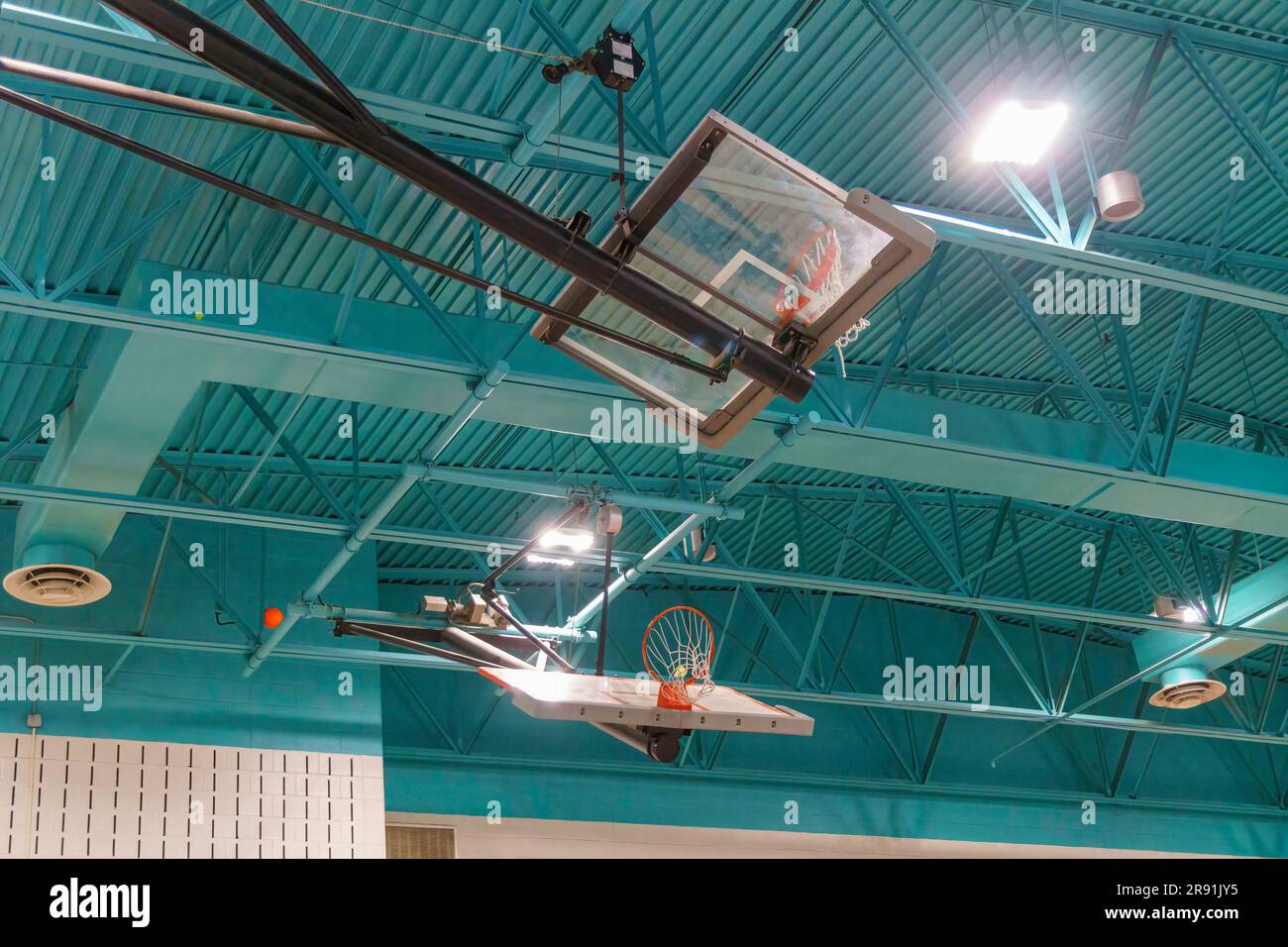 Basketball hoops folded towards the ceiling in a school gymnasium ...