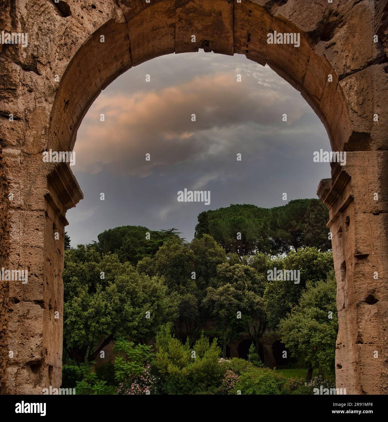 Italian landscape through an archway of the Colosseum in Rome, Italy ...