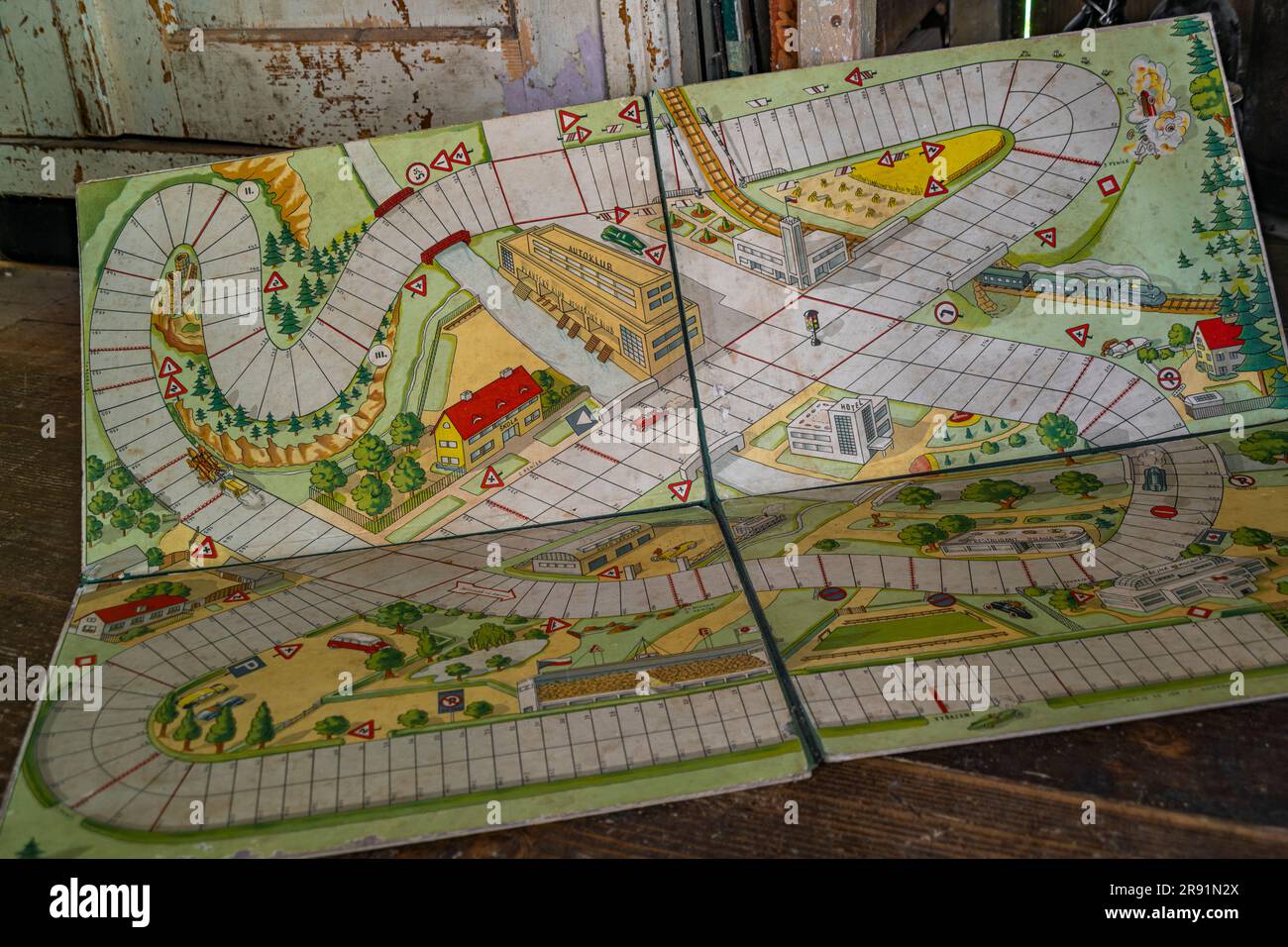 Old table game with small wooden cars on old quality color cardboard ...