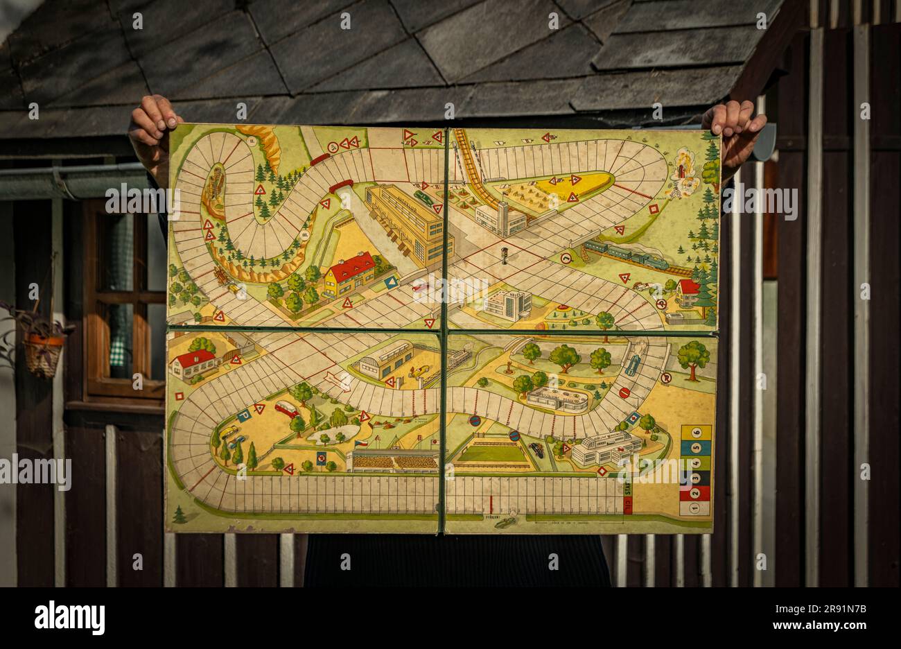 Old table game with small wooden cars on old quality color cardboard ...