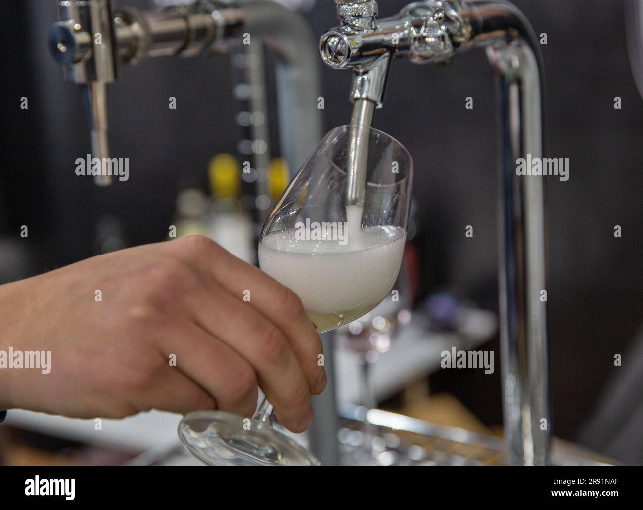 Pouring prosecco sparkling wine from a tap into a glass closeup Stock ...