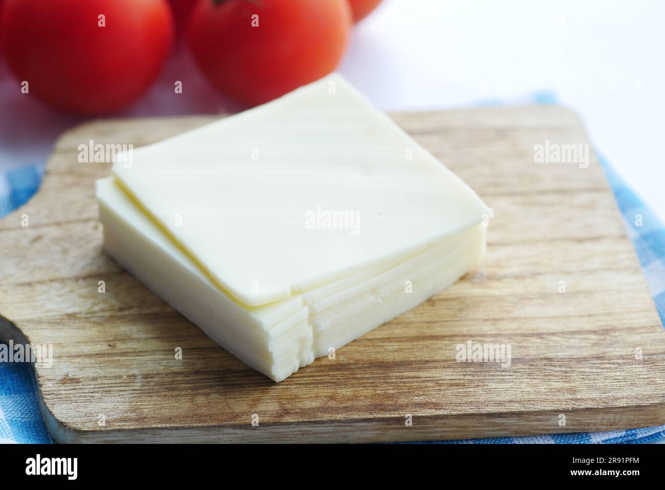 Slicing cheese into pieces closeup Stock Photo - Alamy