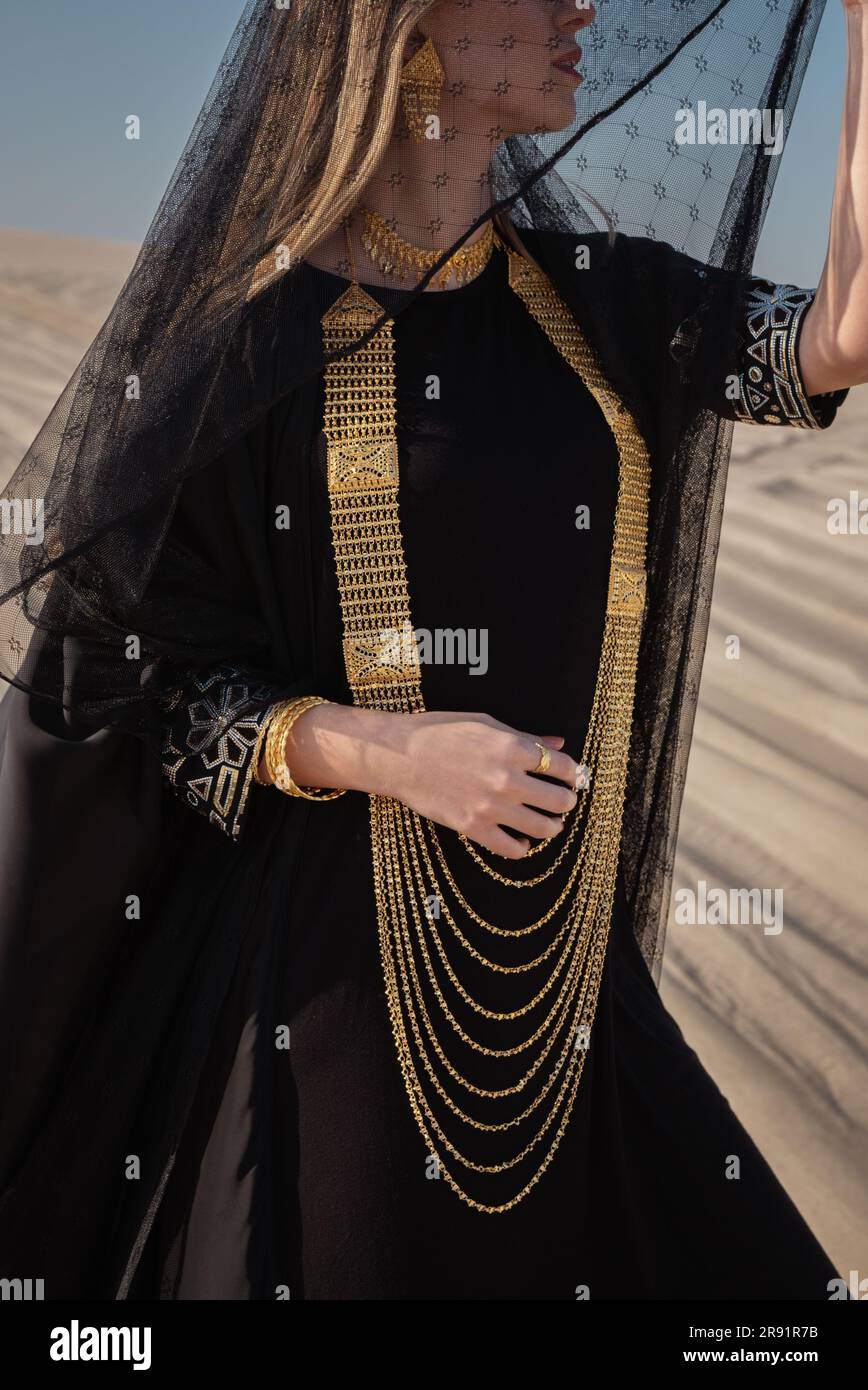 A young woman wearing a traditional Middle Eastern outfit, consisting ...