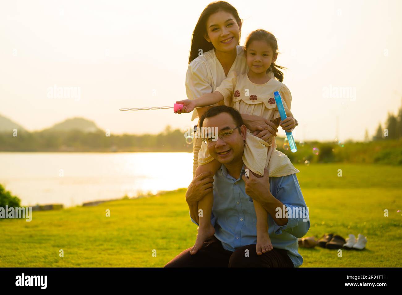 Happy family relaxing and resting in park together on weekend Stock ...